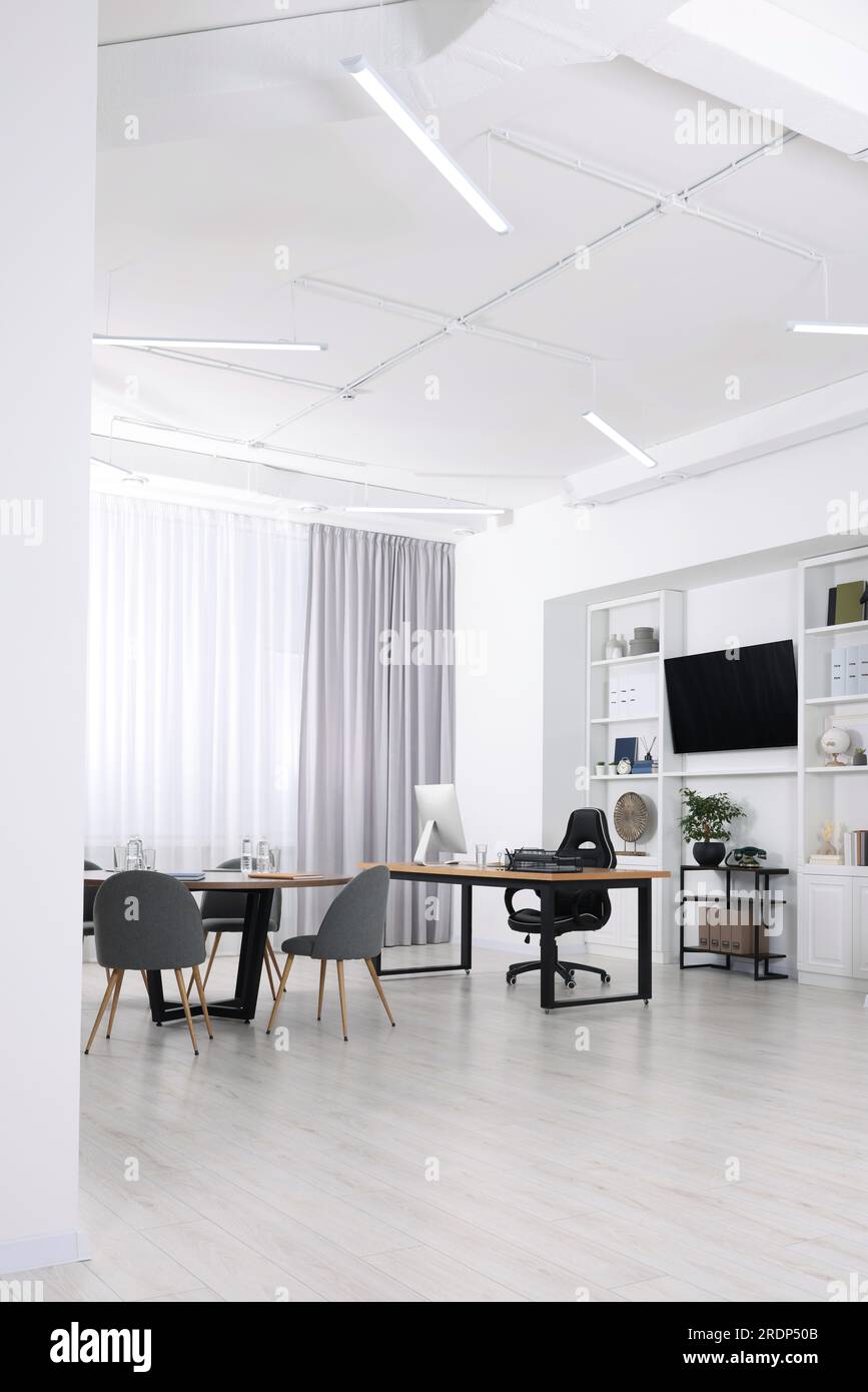 Stylish office with comfortable furniture and tv zone. Interior design ...