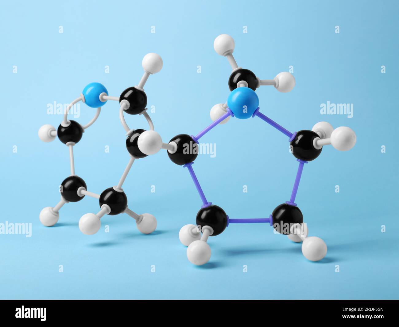 Molecule of nicotine on light blue background. Chemical model Stock ...