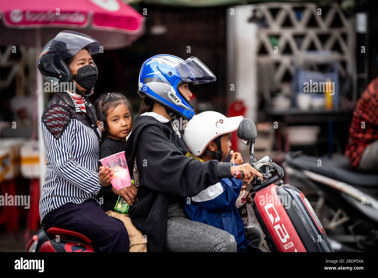 Phnom Penh, Cambodia. 22nd July, 2023. A family rides a scooter in ...