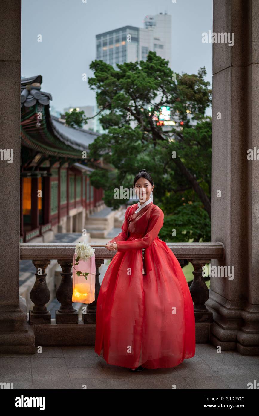 Pretty Korean girl wearing traditional Hanbok dress in Deoksugung ...