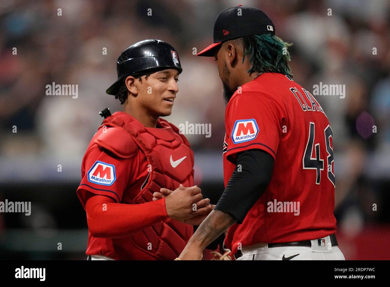 Cleveland Guardians catcher Bo Naylor, left, shakes hands with relief ...