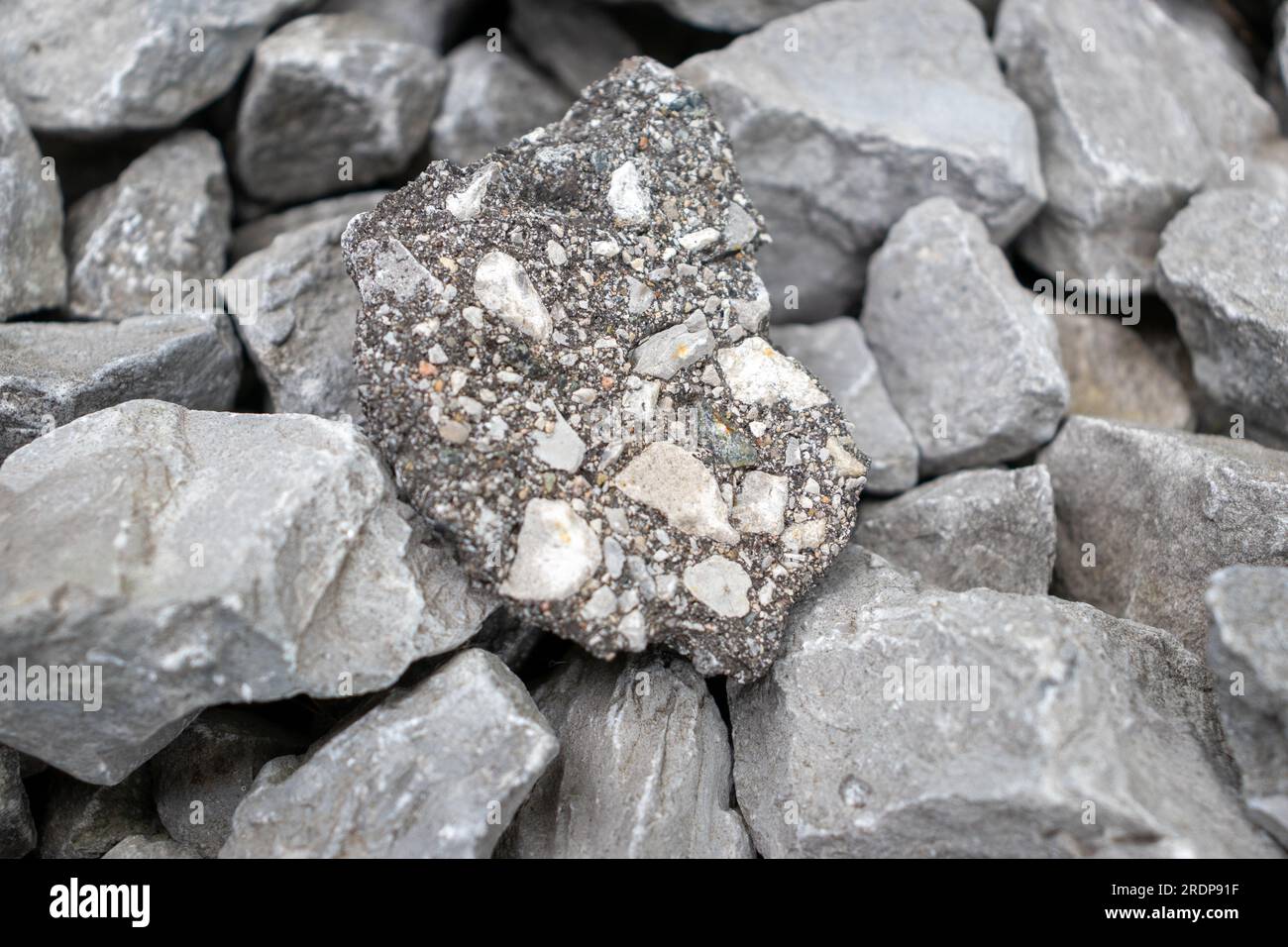 Close up of rough textured black and white rock among similar rocks in ...