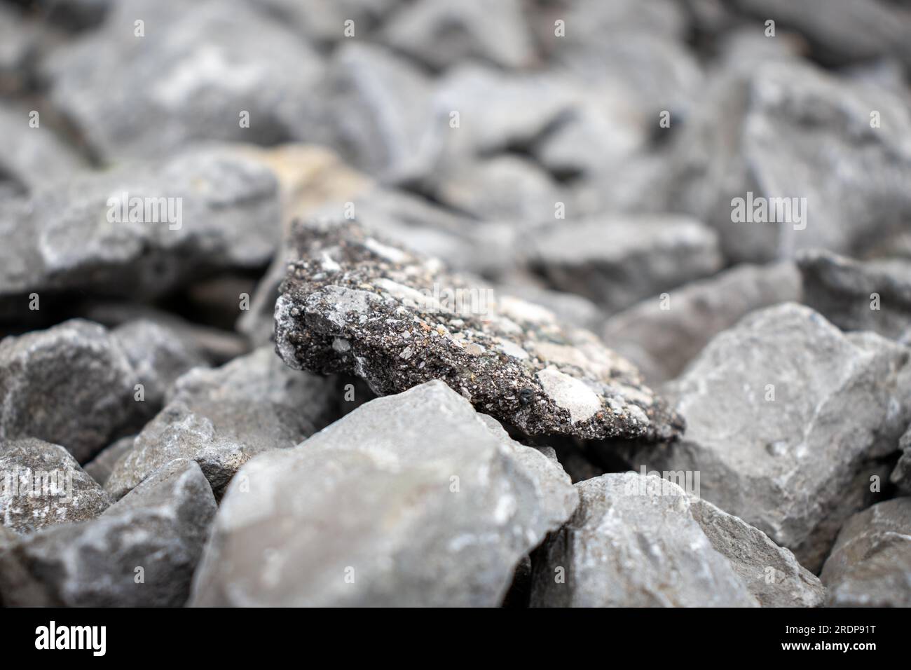 Close up of rough textured black and white rock among similar rocks in ...