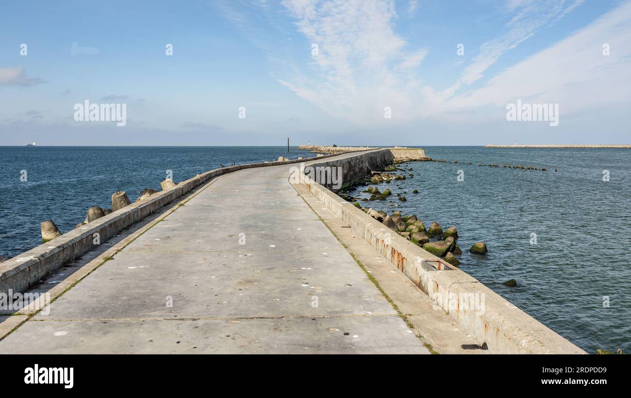 Southern long concrete pier with breakwaters on the Baltic Sea on the ...