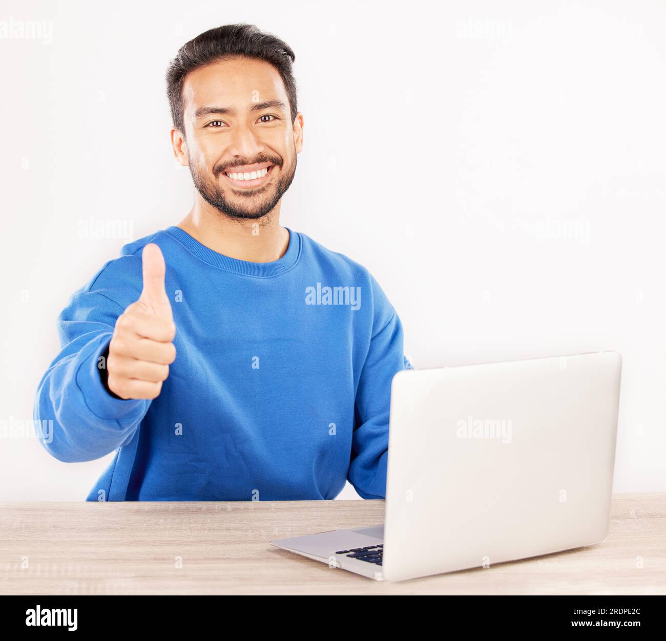 Portrait, laptop and thumbs up with an IT support man at his desk in ...