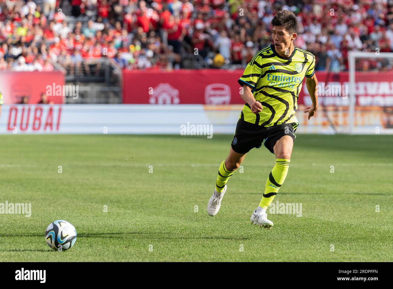 Takehiro Tomiyasu (18) of Arsenal FC chases ball during friendly game ...
