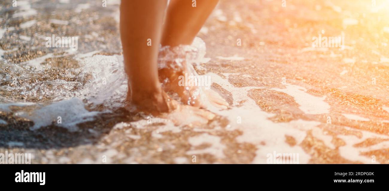 A woman walks along the beach, legs close-up. Barefoot woman sta Stock ...