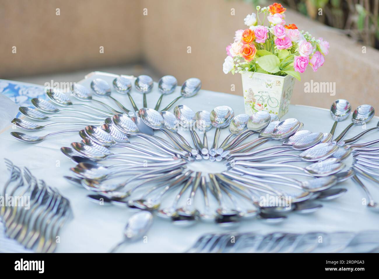 The hotel's banquet spoon arrangement is paired with flower vases to ...