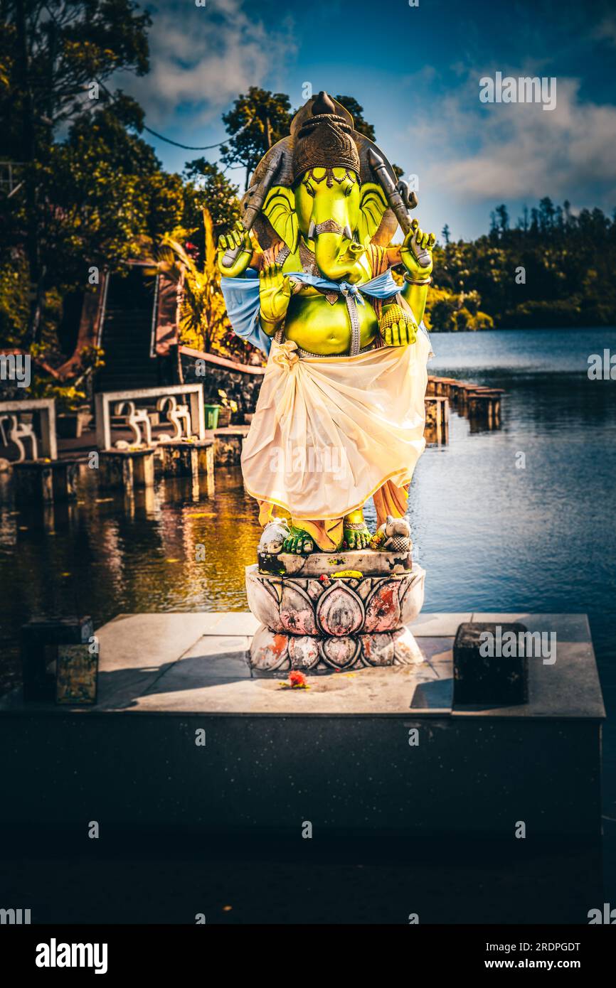Asian Hindu statue in Mauritius and Bali. Gods temple and water ...