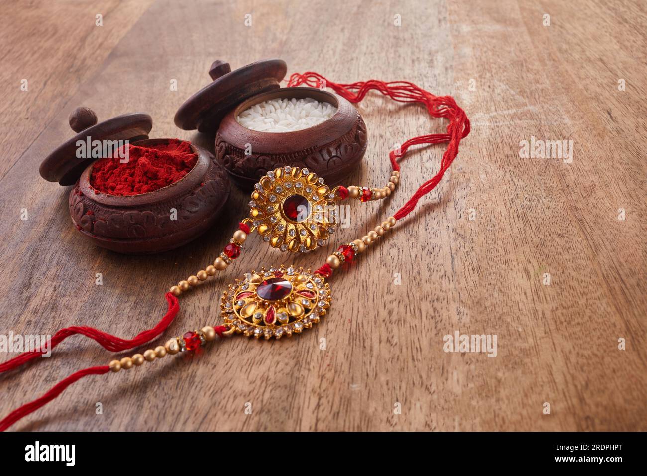 Raksha Bandhan background with Rakhi string, Rice Grains and Kumkum ...