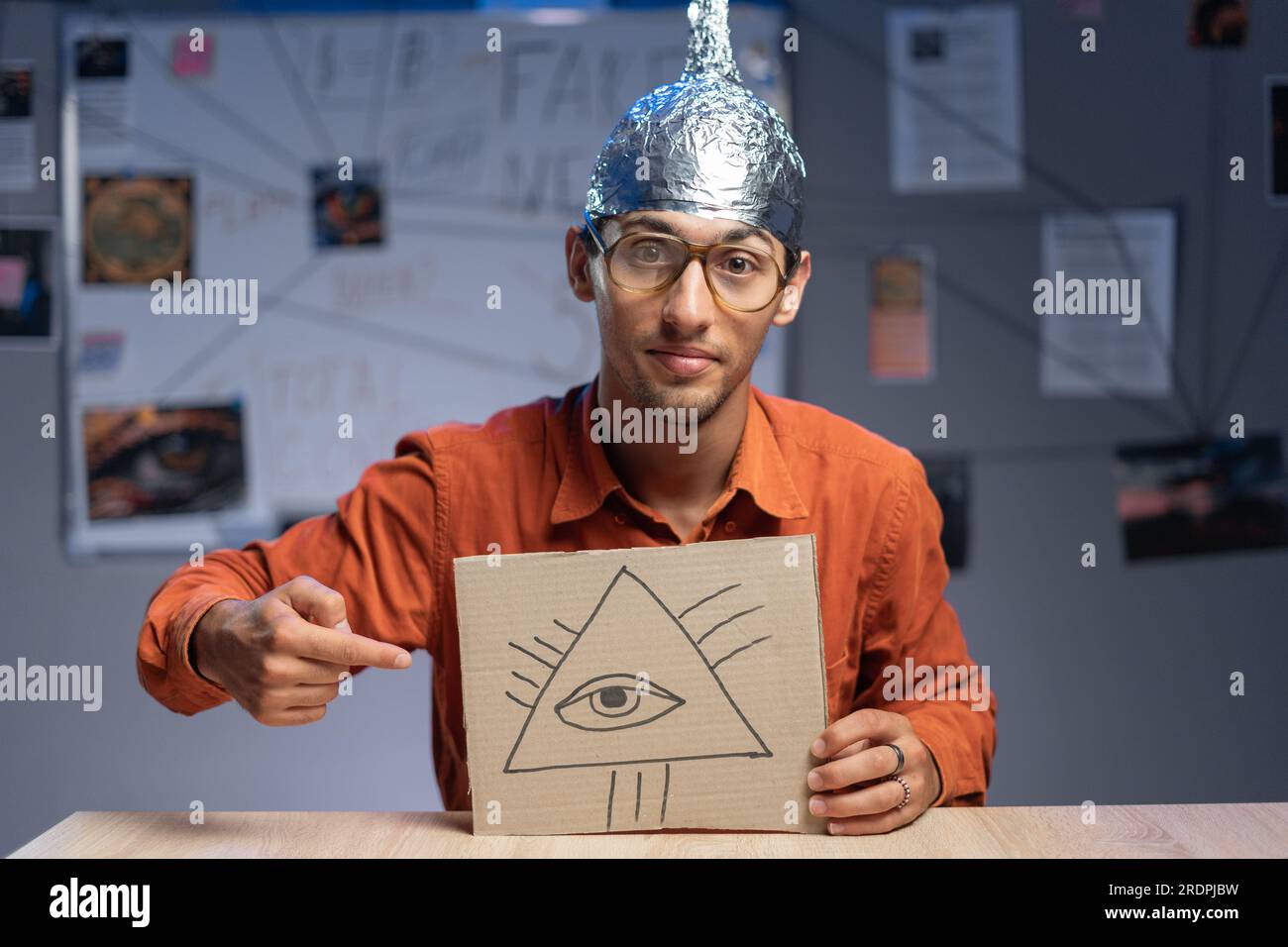 Strange man in a foil hat with masonic symbol All-seeing eye of God ...