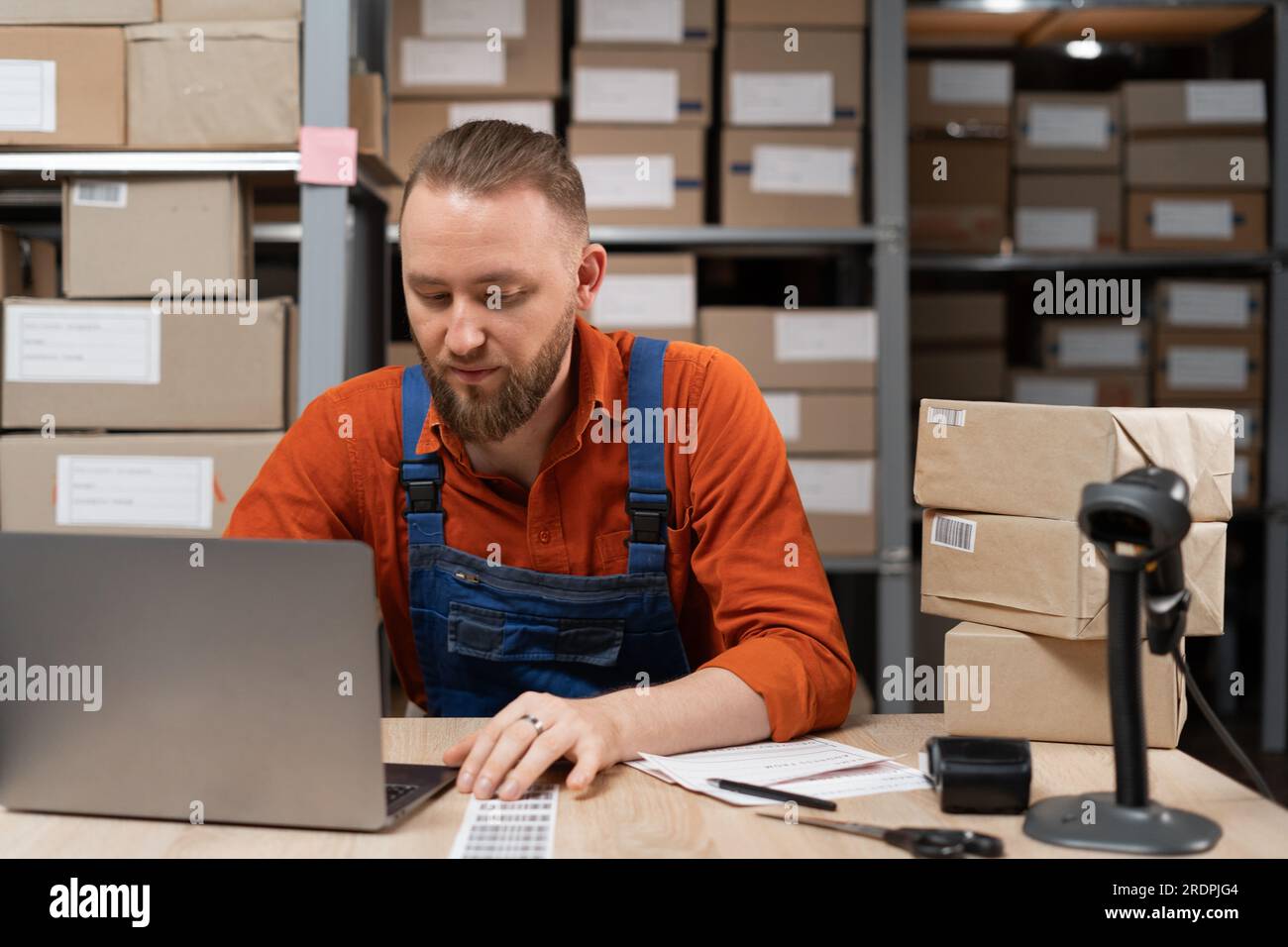 Manager using laptop computer to check inventory while working in ...