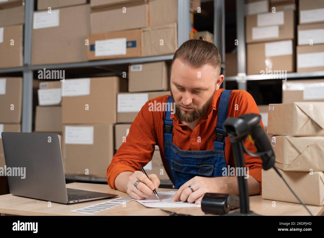 Professional male worker using laptop computer checking stock and ...