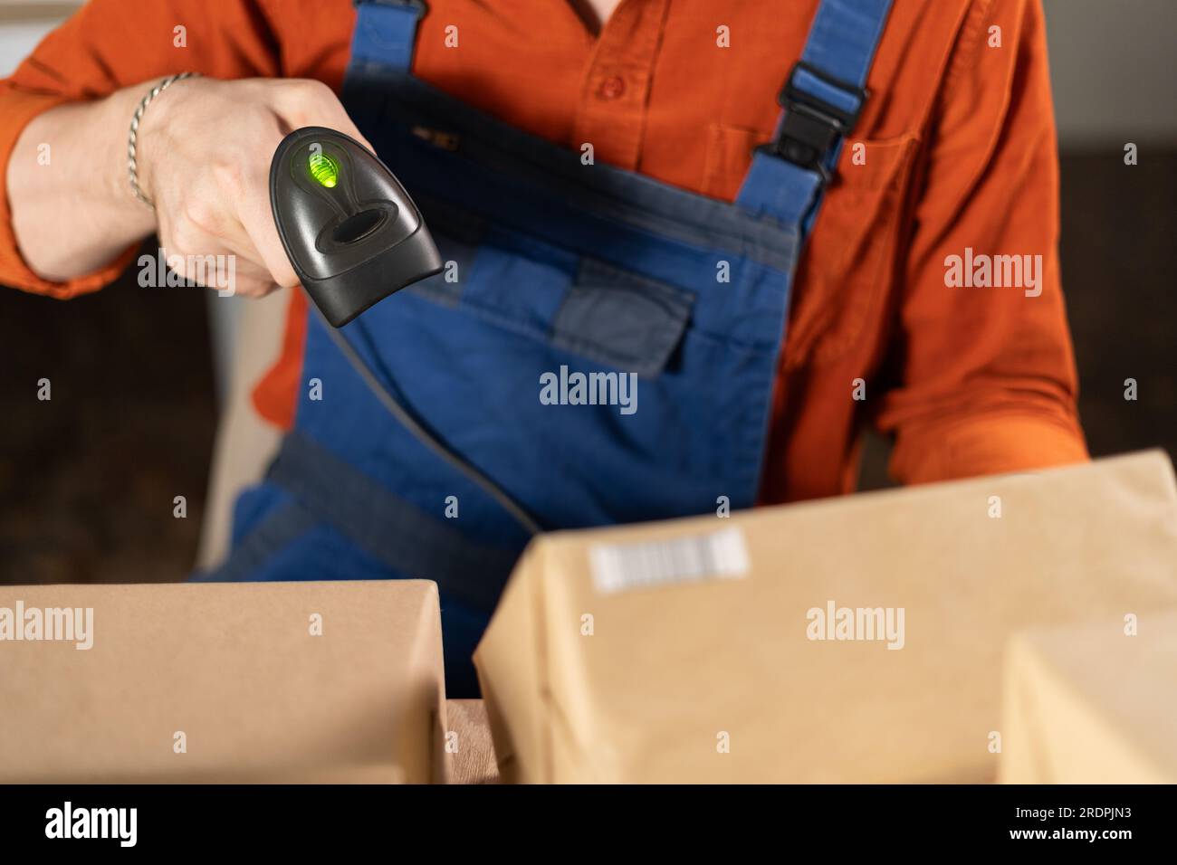 Scanning barcode on delivery parcel. Worker hands scan barcode of ...