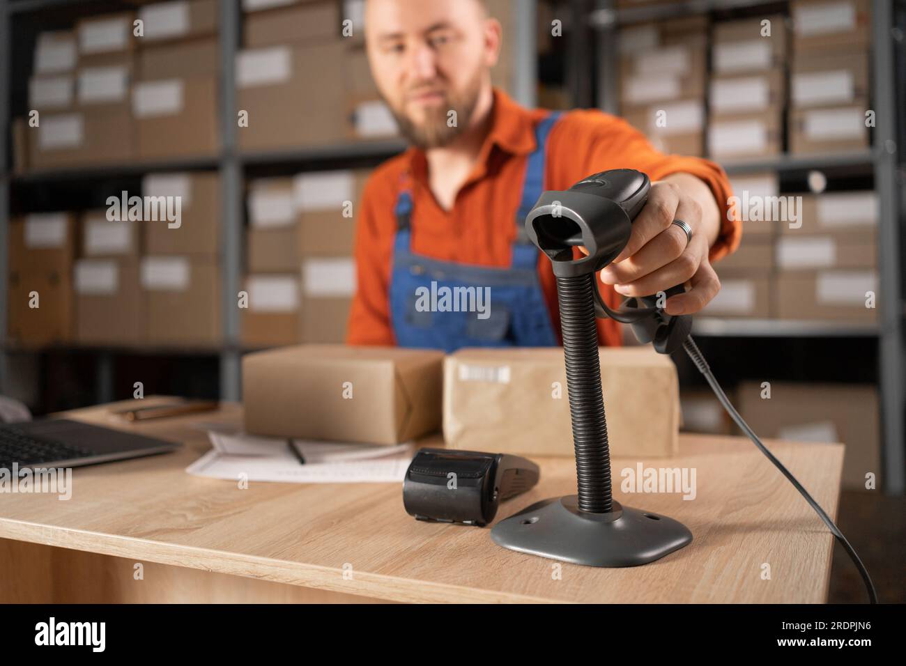 Male worker using scanner scanning parcel barcode tag packing ecommerce ...
