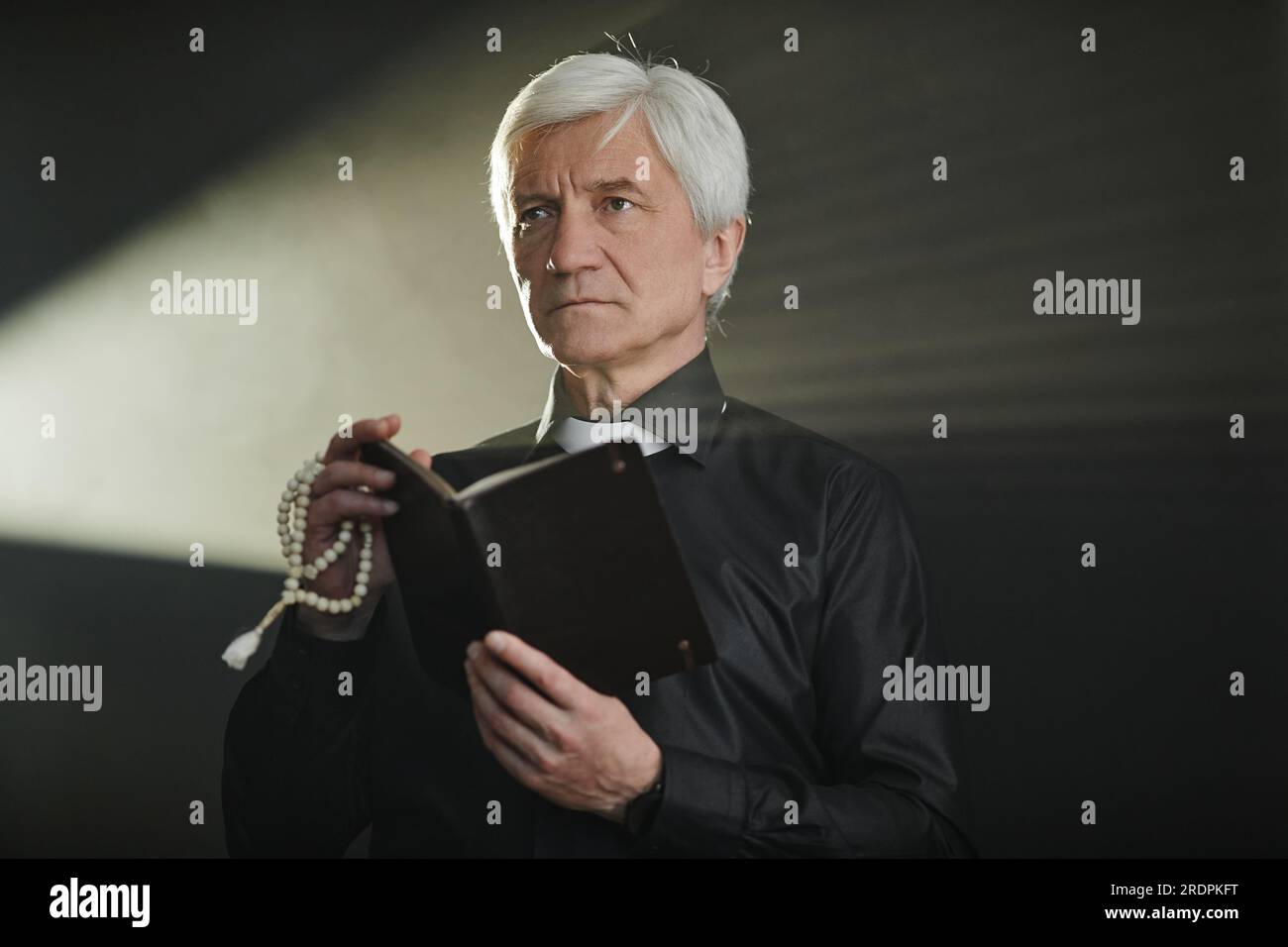 Handsome catholic priest holding hi-res stock photography and images ...