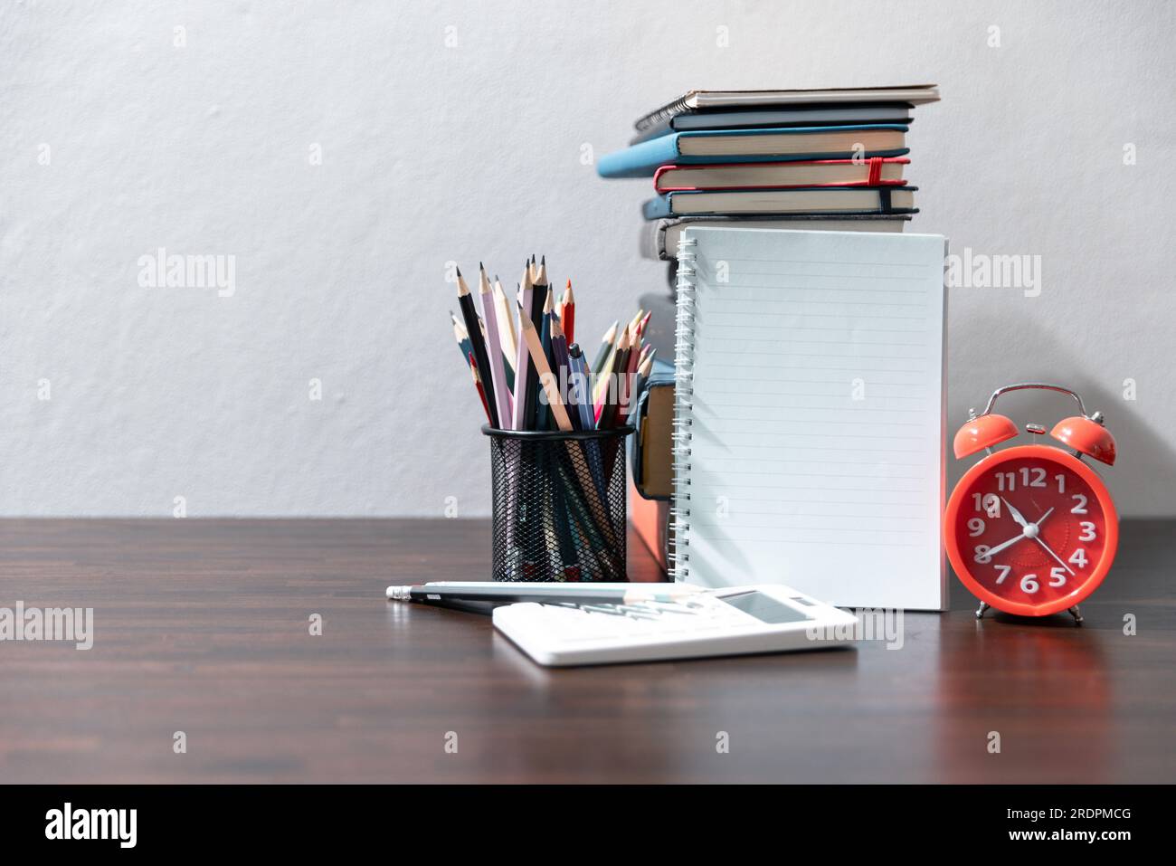 Back to school background with books on wooden table over chalkboard ...