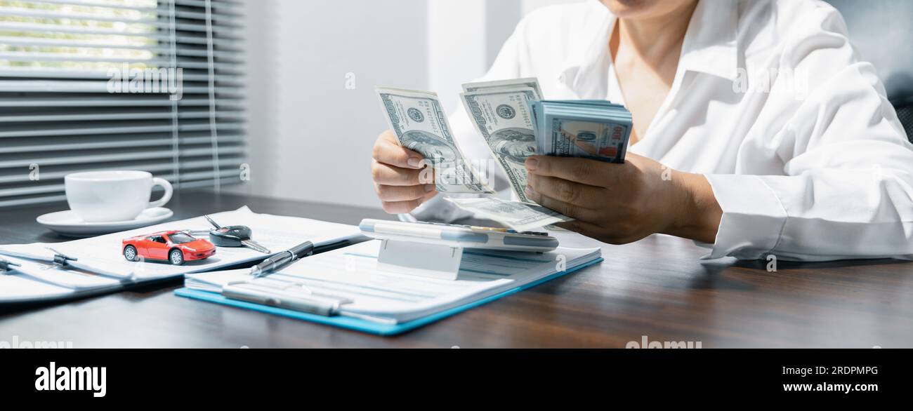 Car salespeople with cash with model cars to customers with concept of ...