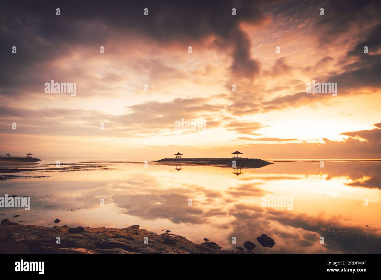Sunset or sunrise on the beach in Bali in Sanur. beautiful temples in ...