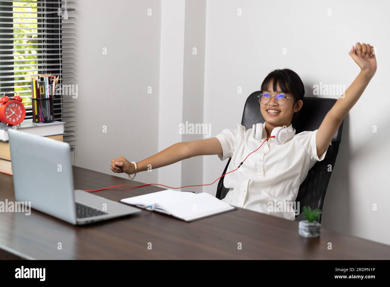 School age student doing her homework with digital tablet at home ...
