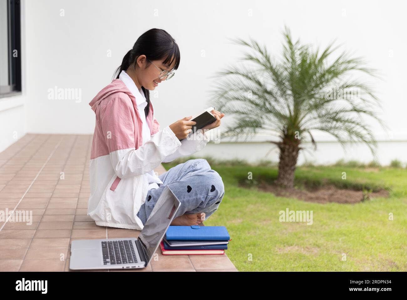 Student teen girl with glasses online learning with laptop computer ...