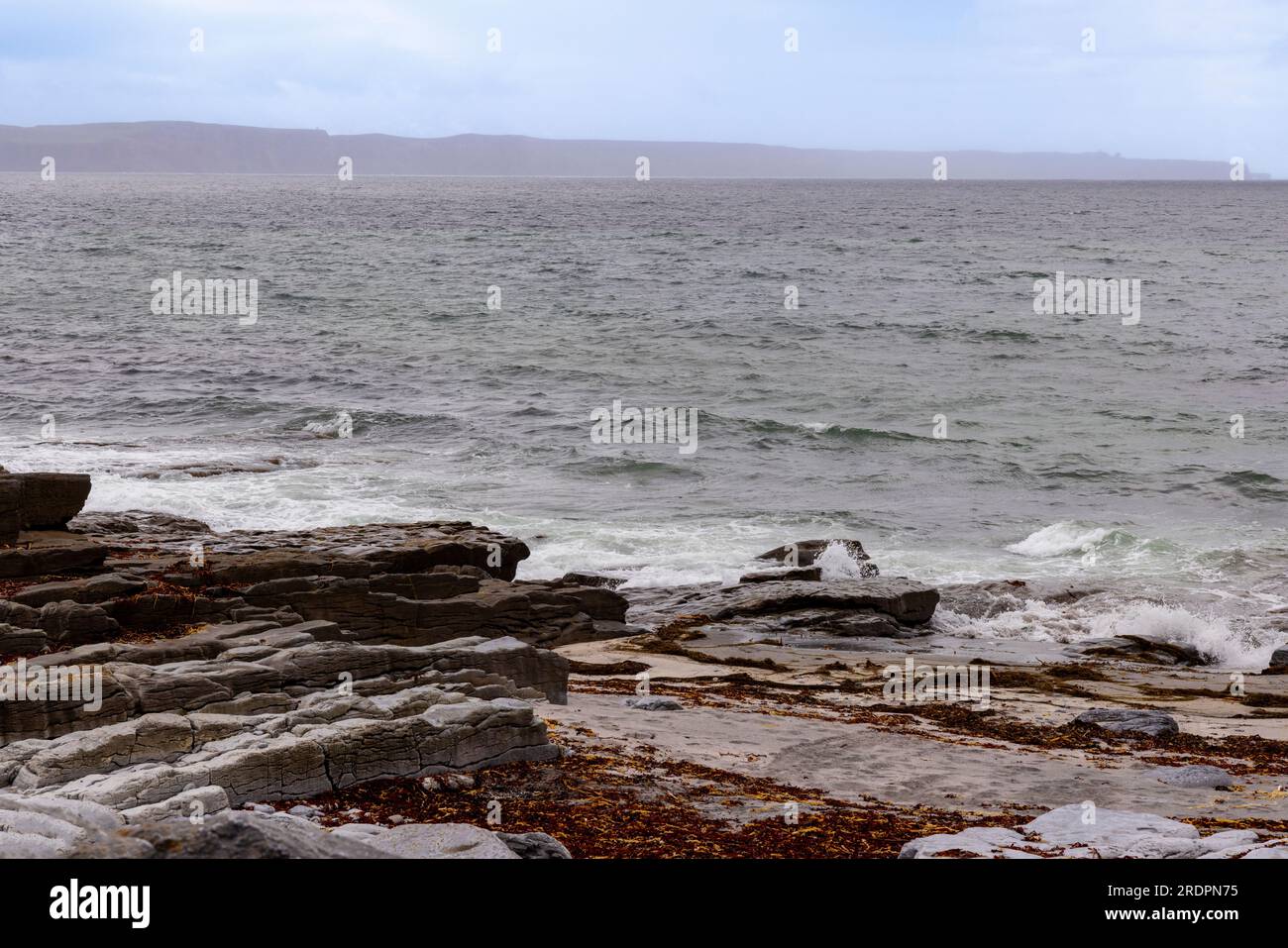 Limestone coast of Inis Oirr or Inisheer on Galway Bay with hazy view ...