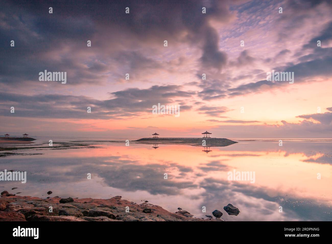 Sunset or sunrise on the beach in Bali in Sanur. beautiful temples in ...