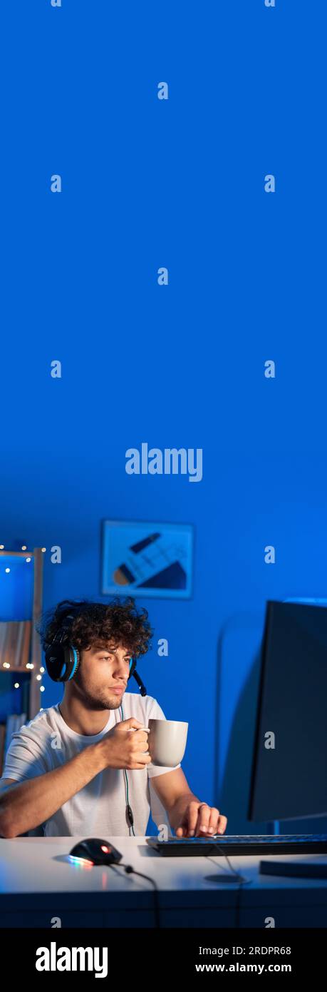 Young arabic gamer wearing headphones playing video game on personal ...