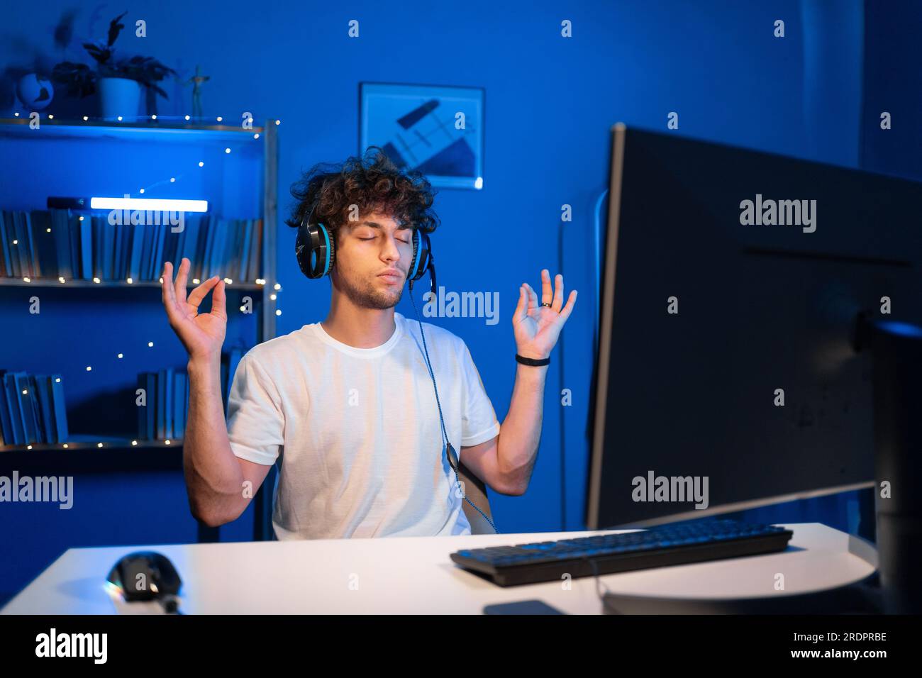 Arabic guy gamer meditates sitting before computer in a headset at ...