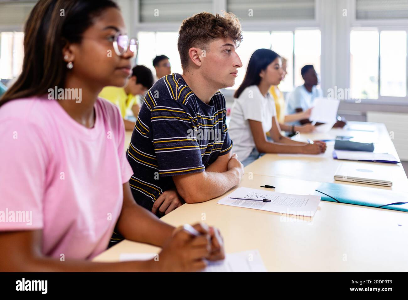 Group of high school students listening teacher during lecture in ...