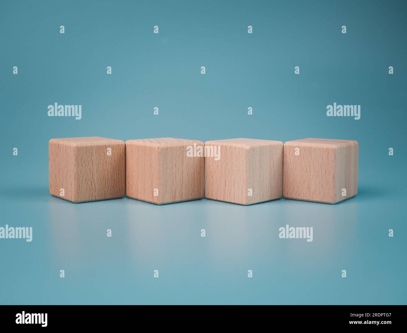 empty wooden blocks lined up on light blue background. Business concept ...