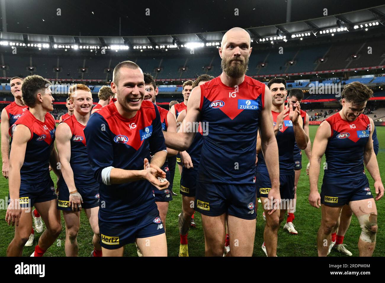 Ed Langdon of Melbourne (right) leads teammates from the field during ...