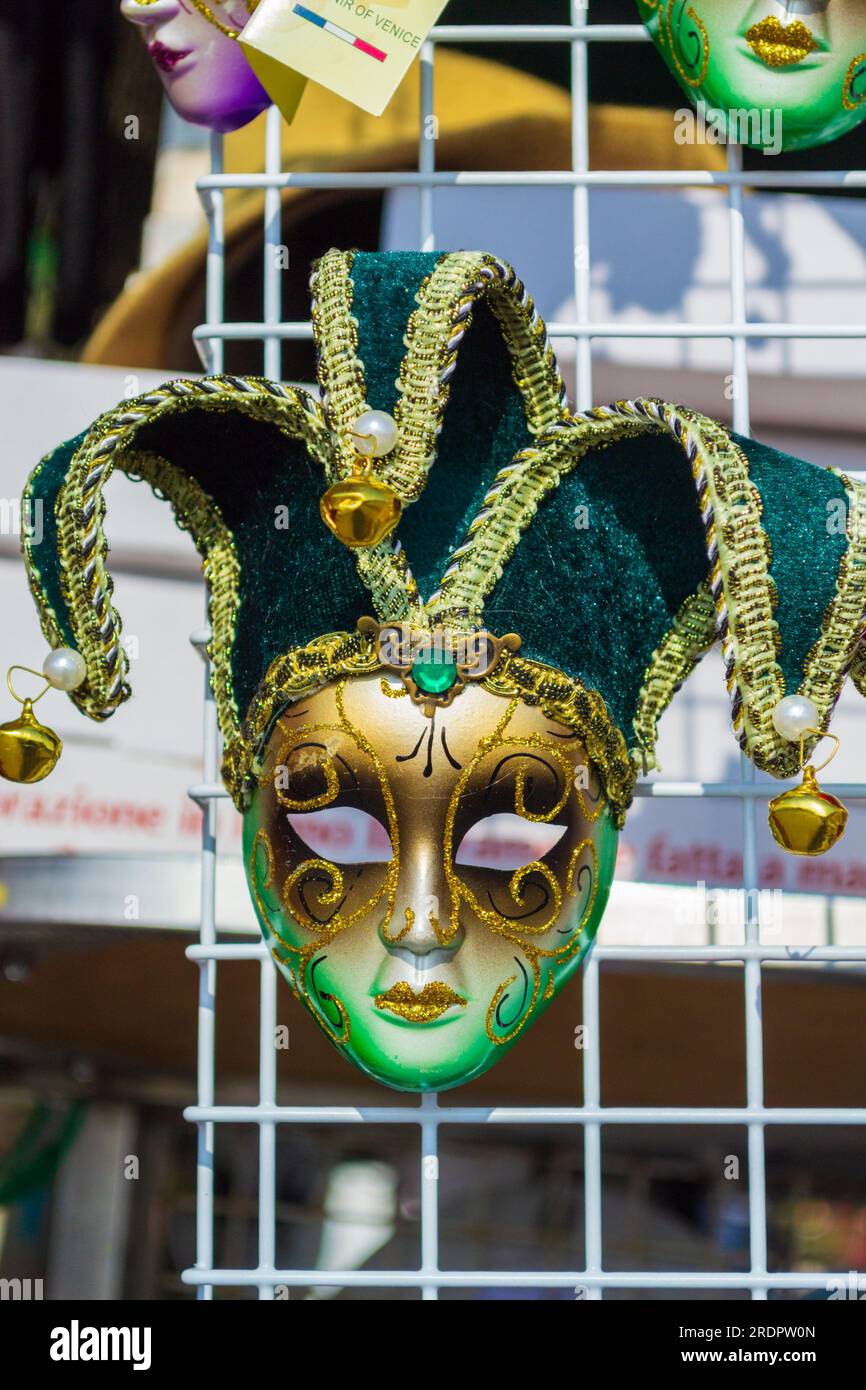 Impressive colorful carnival masks displayed on vendor stand in front ...