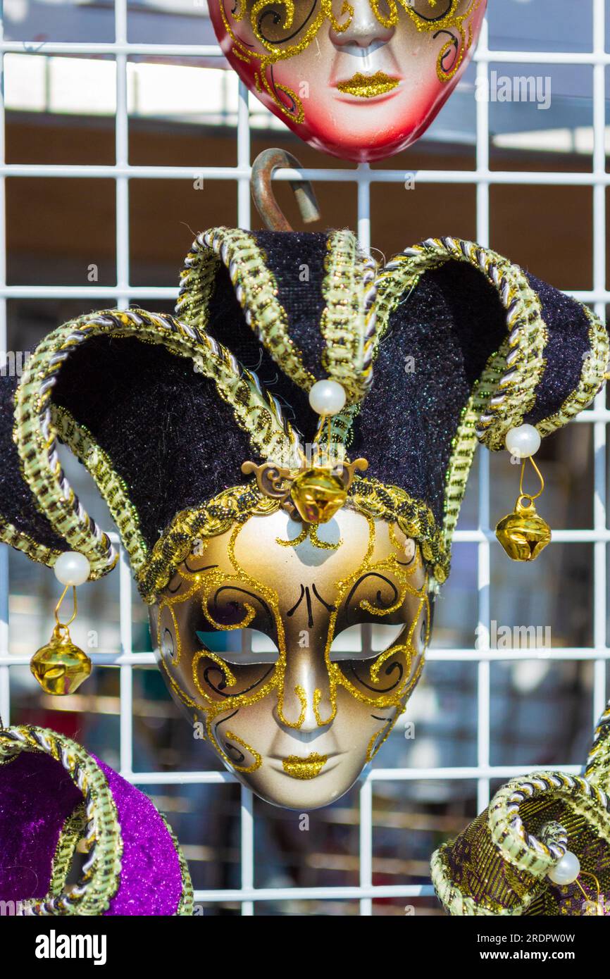 Impressive colorful carnival masks displayed on vendor stand in front ...
