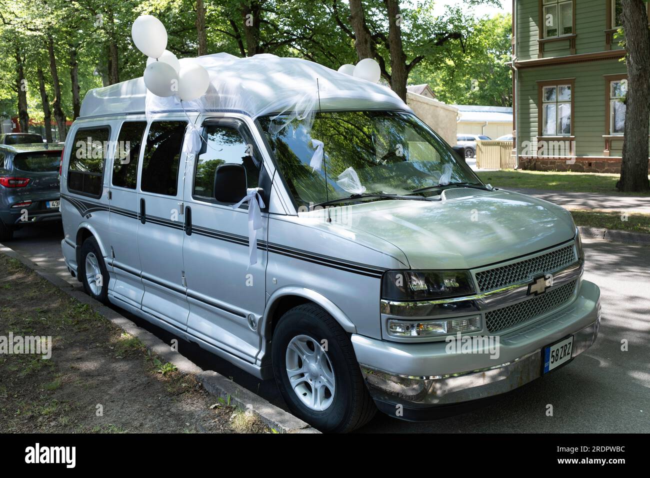Beautiful wedding car. Van decorated with white balloons and fabric on ...