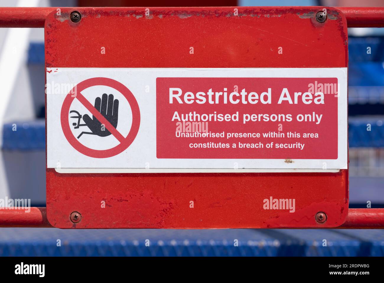 Red and white restricted area sign, authorized persons only, with hand ...