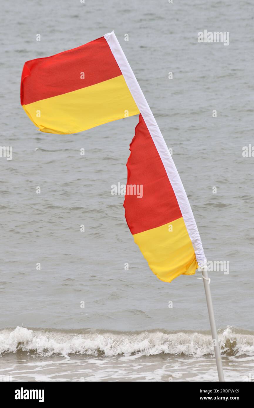 Red and Yellow Flags on Beach warning to swimmers Lyme Bay Lyme Regis ...