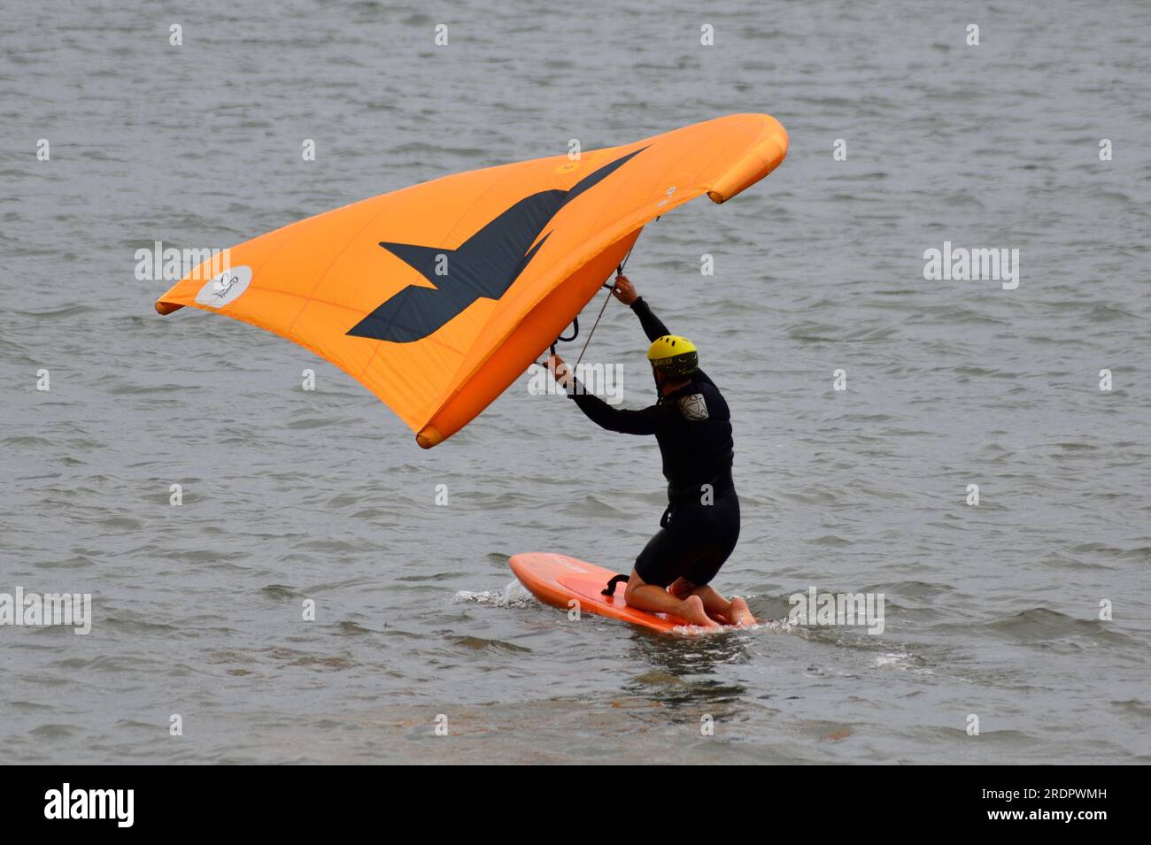 Wind Foiling in Action at Lyme Bay Lyme Regis Dorset England uk Stock ...