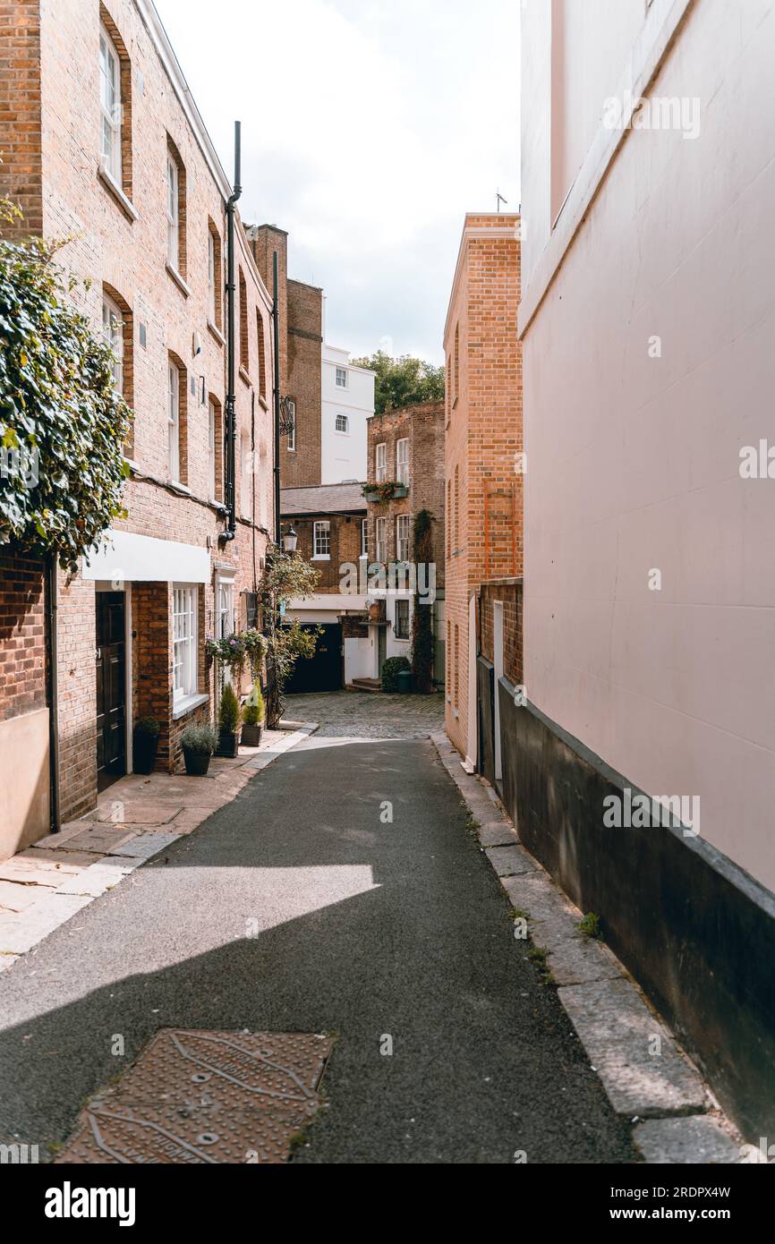 Cute little brick buildings in a quiet alley Stock Photo - Alamy