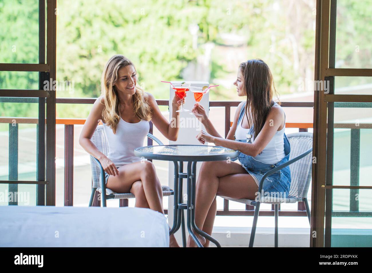 Two ladies best friends are having drinks summer vacation concept Stock ...