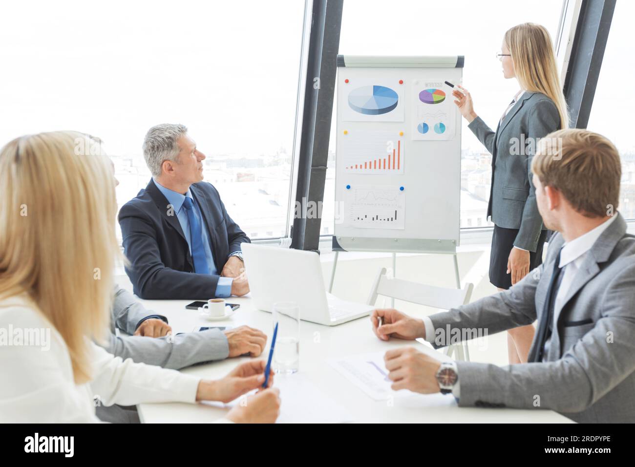 Business people at presentation in office. Businesswoman presenting ...