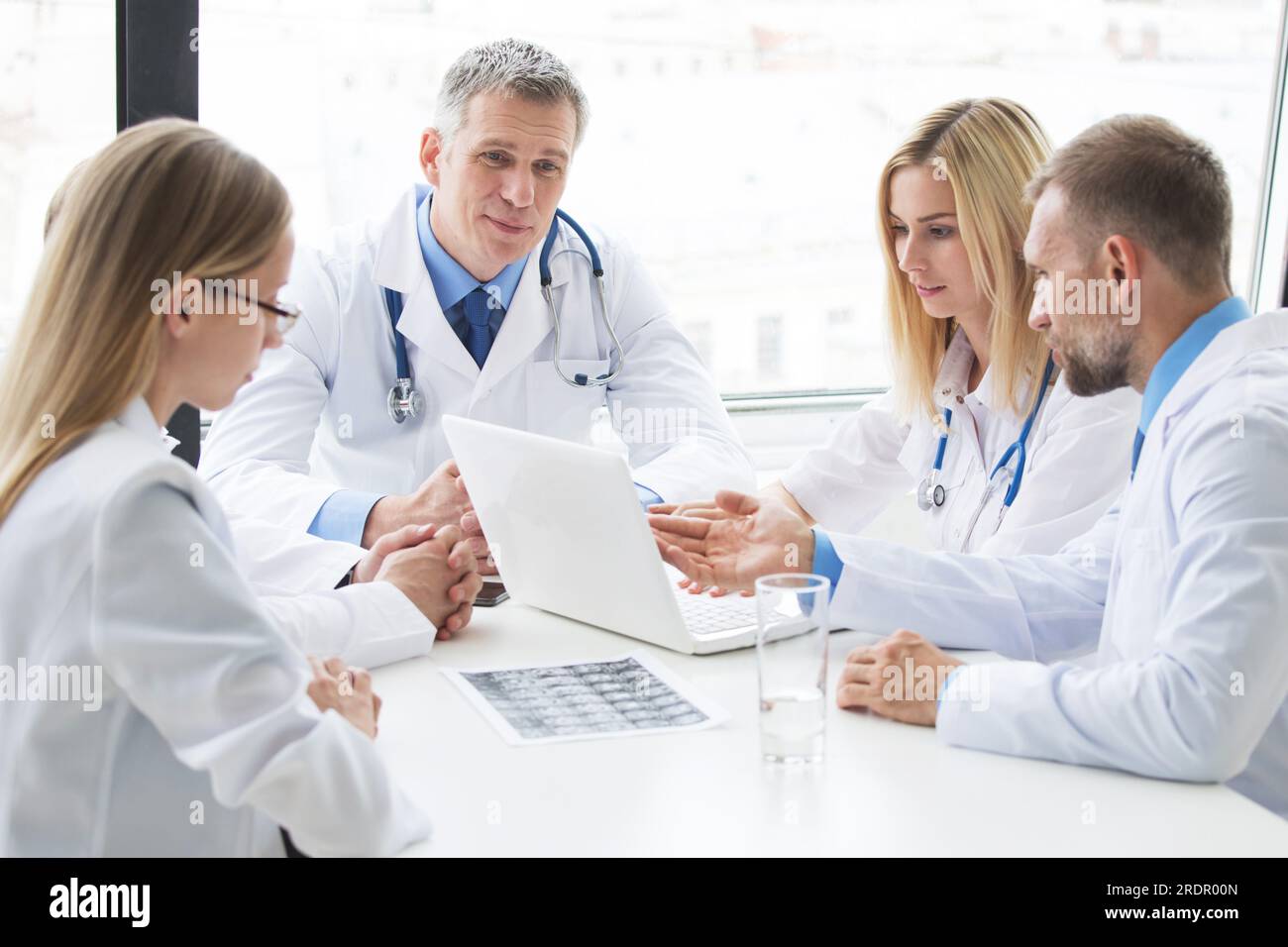 Medical, meeting and laptop for team in office in discussion, brainstorming and planning ...