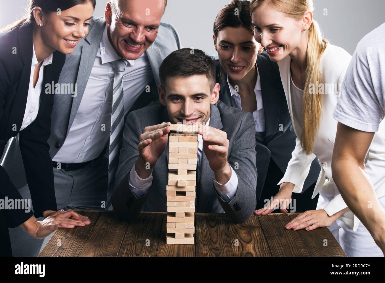 Business people team building wood puzzle tower cooperation concept ...