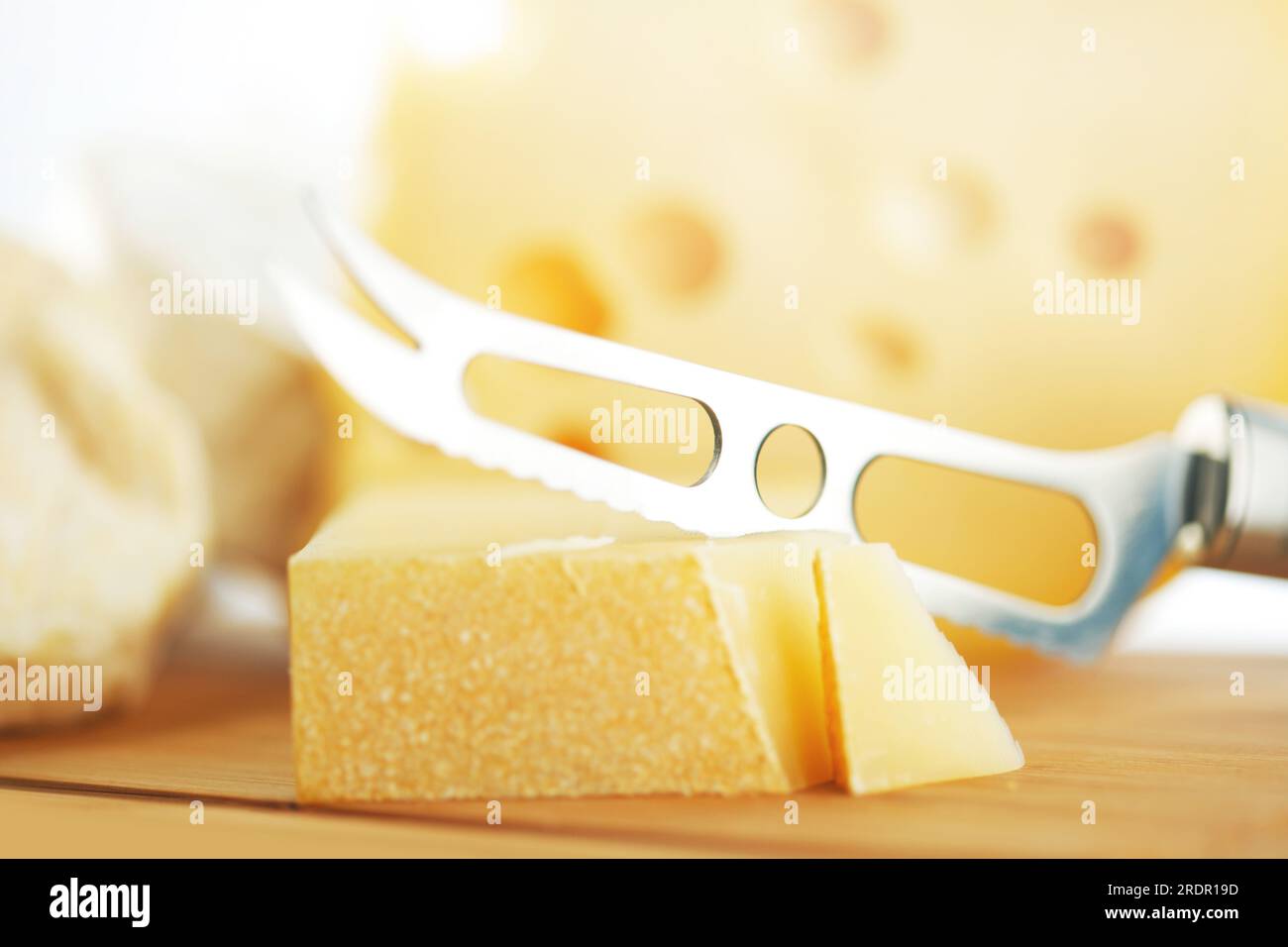 cheese with a cheese knife Stock Photo - Alamy