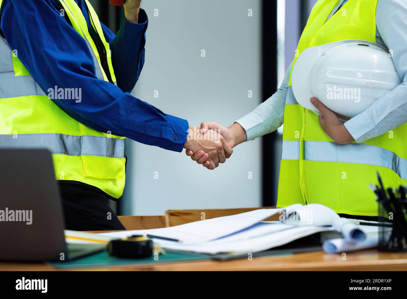 Civil engineers and architects handshake after work done at the office ...