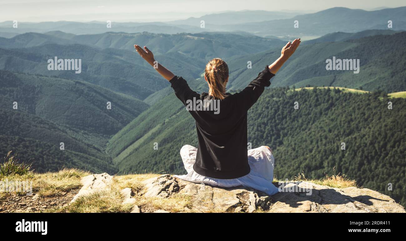 Young woman on the top of mountain Stock Photo - Alamy
