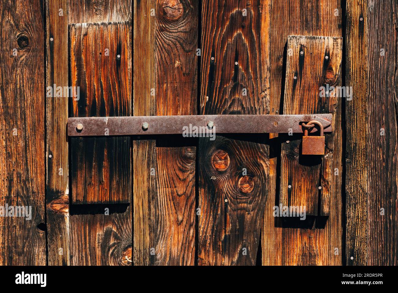 Old rusty corroded padlock on wooden farm barn door as background Stock ...