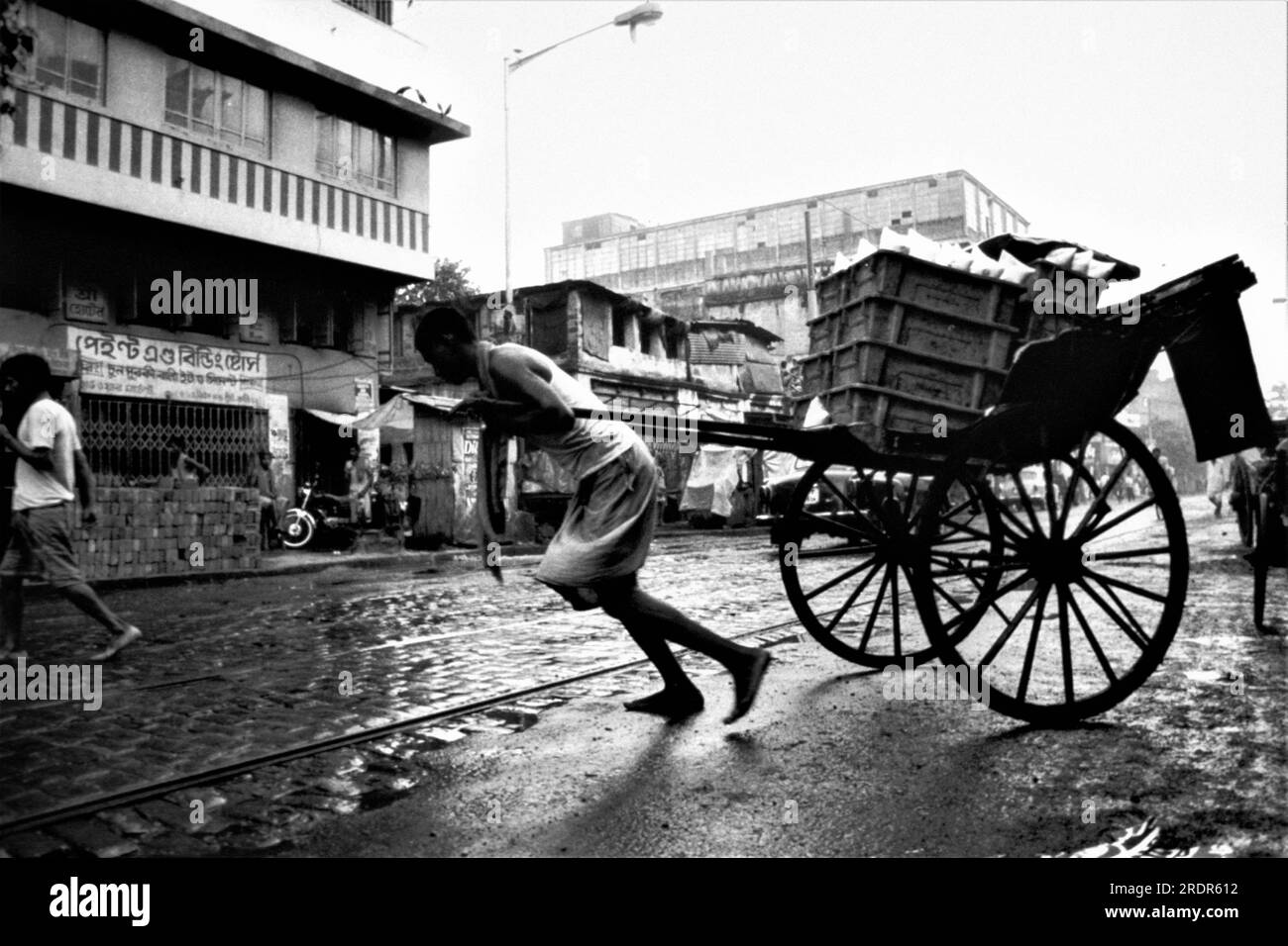 old vintage 1900s black and white picture of Indian man pulling loaded ...