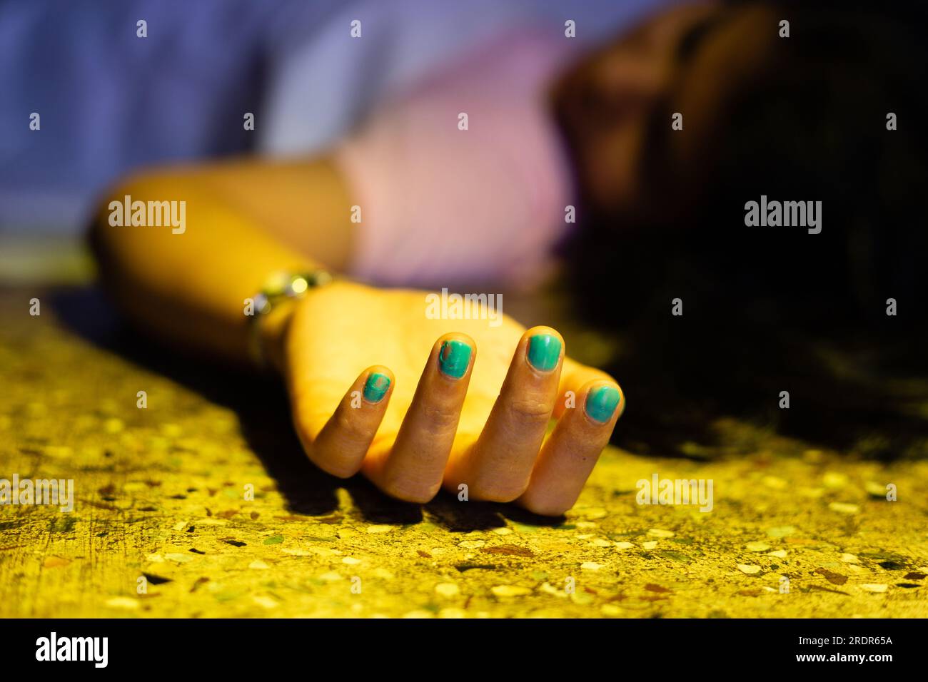An Indian Or Asian Woman Dead Body With Outstretched Hand Lying On Floor In A Dark Room Stock