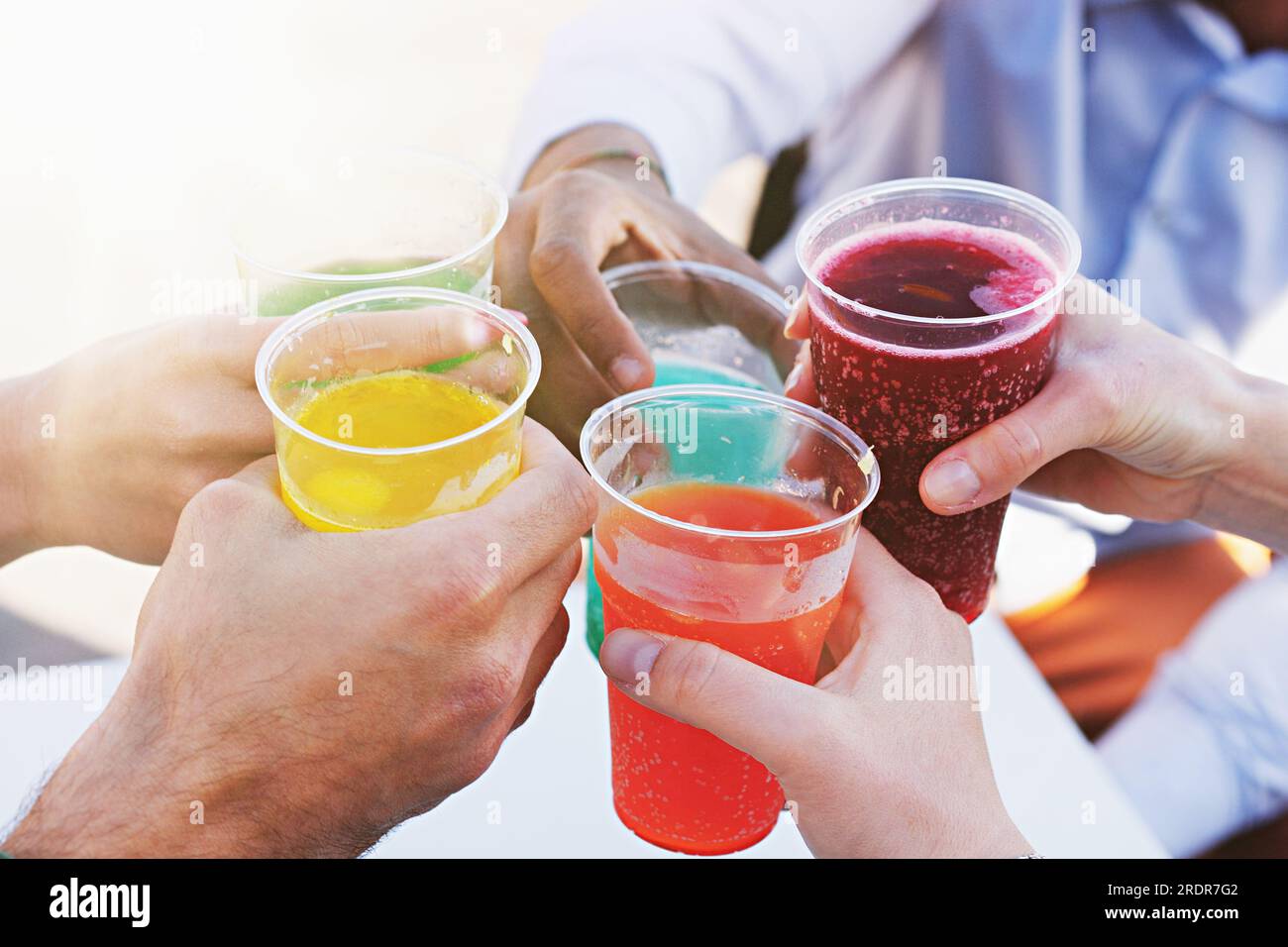 Detail on the hands of a group of young people holding colorful ...